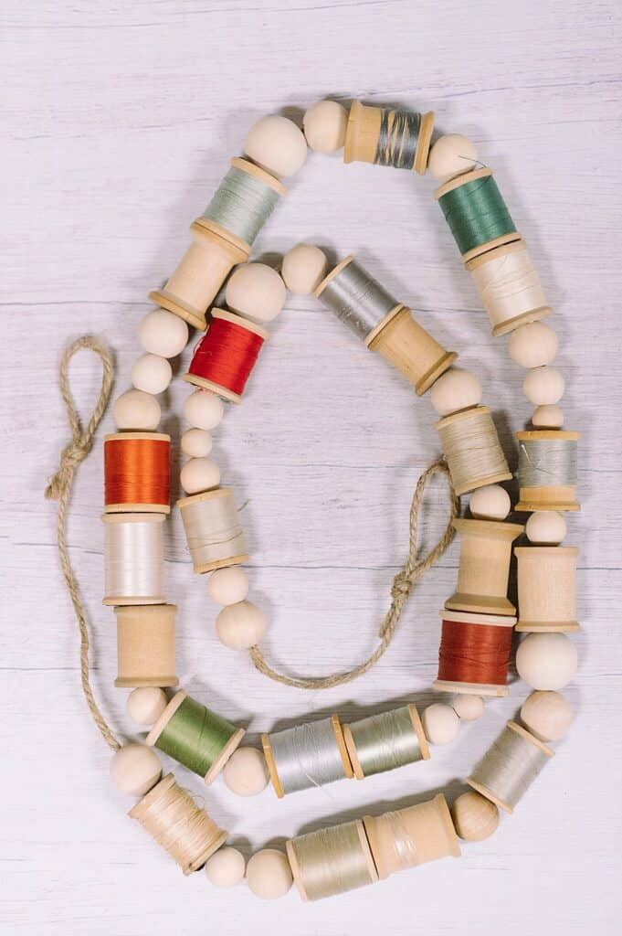 DIY Thread Spool and Wood Bead Garland for Christmas - Laura Radniecki