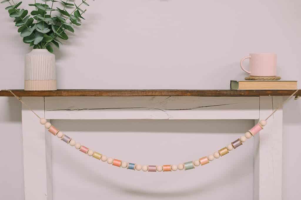 How to Make a Garland for Spring with Wood Beads and Spools - Laura ...